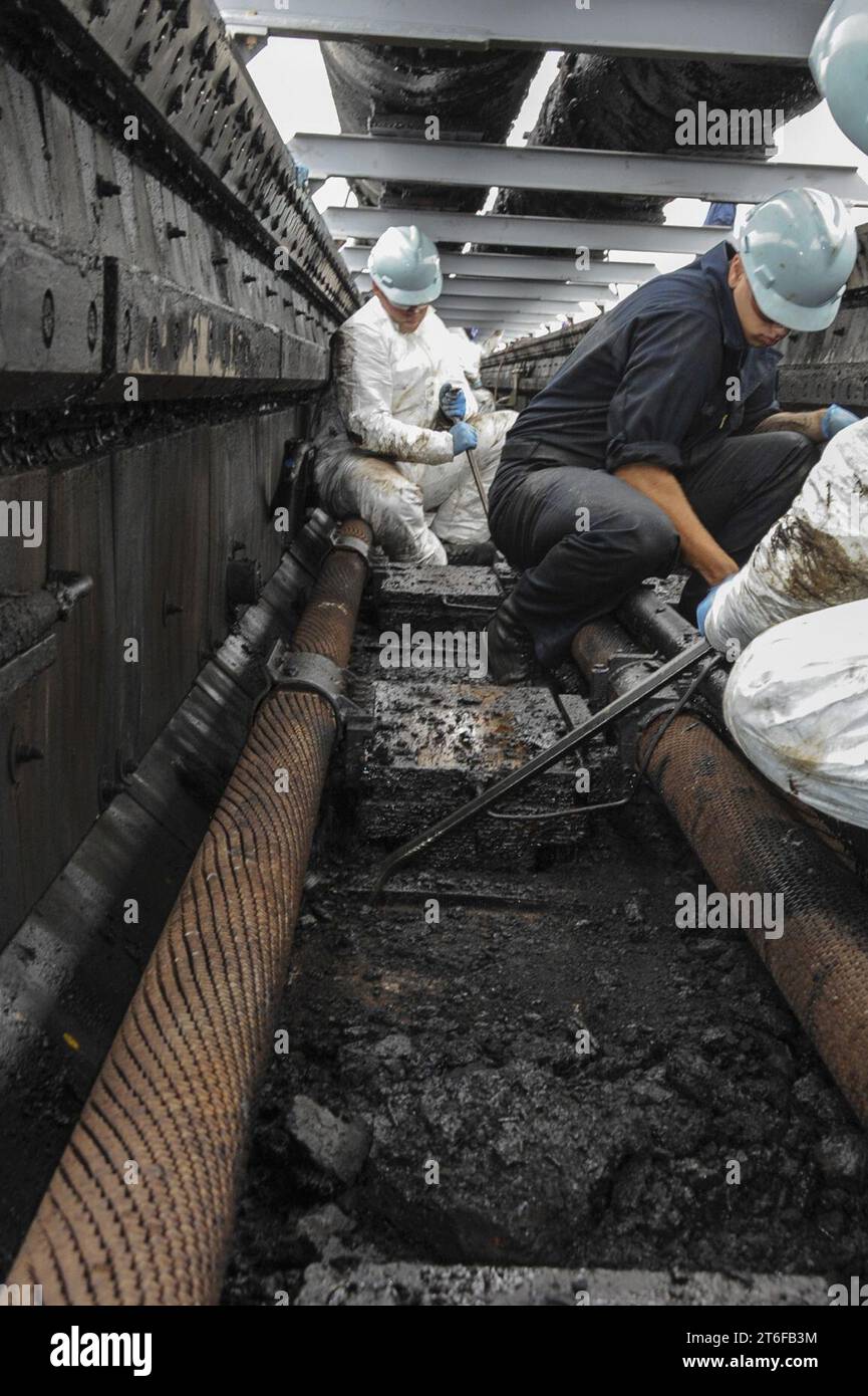 USS Ronald Reagan sailors clean catapult trench 140904 Stock Photo - Alamy