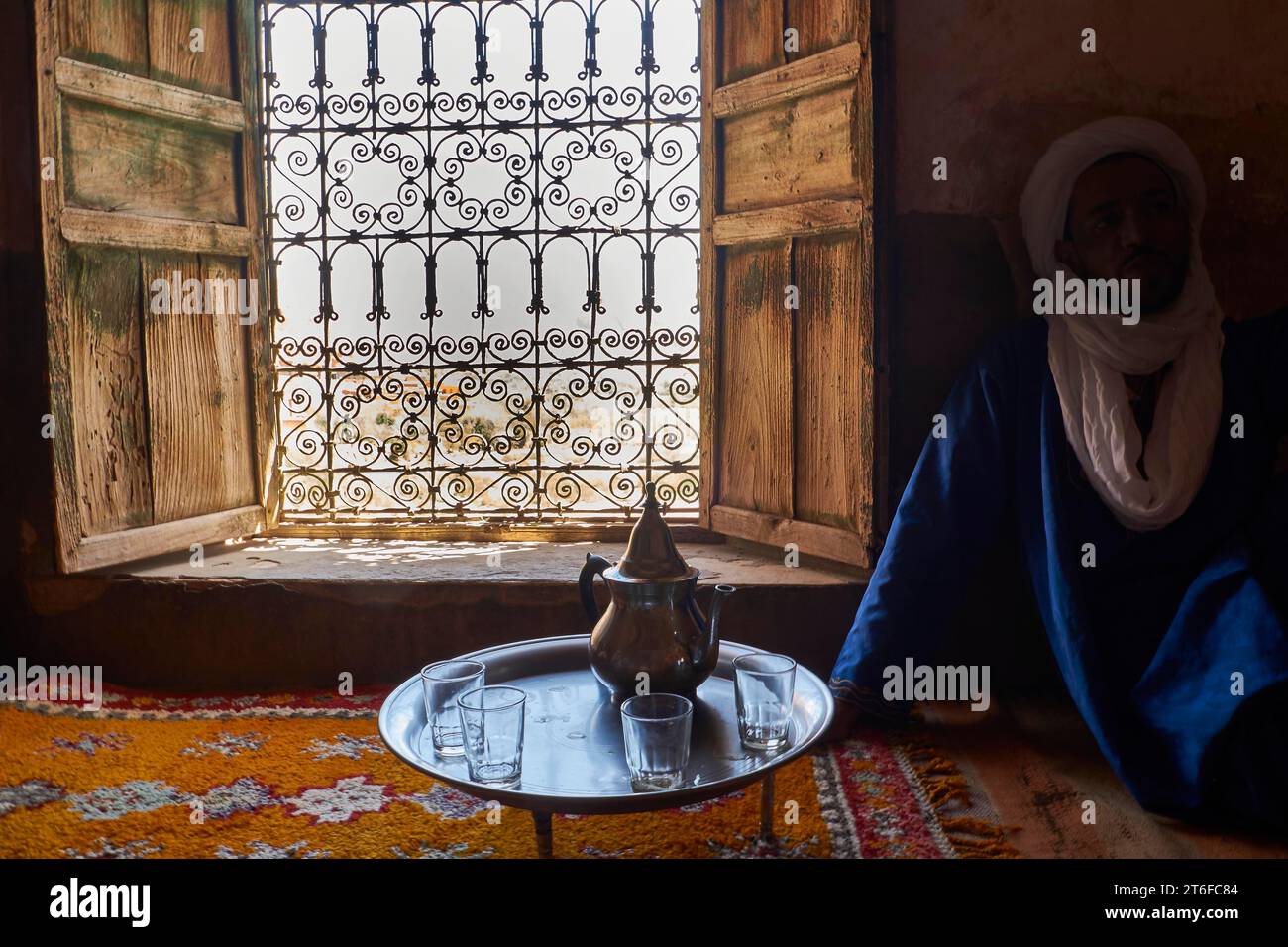 Tea time with a Muslim in a traditional robe within the walls of an old ...