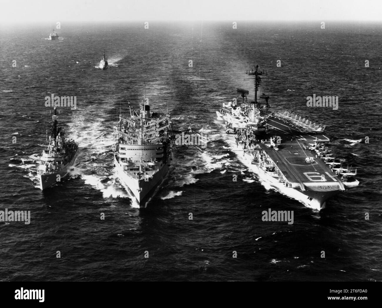 USS Sacramento (AOE-1) refuels USS Hancock (CV-19) and USS Robison (DDG ...