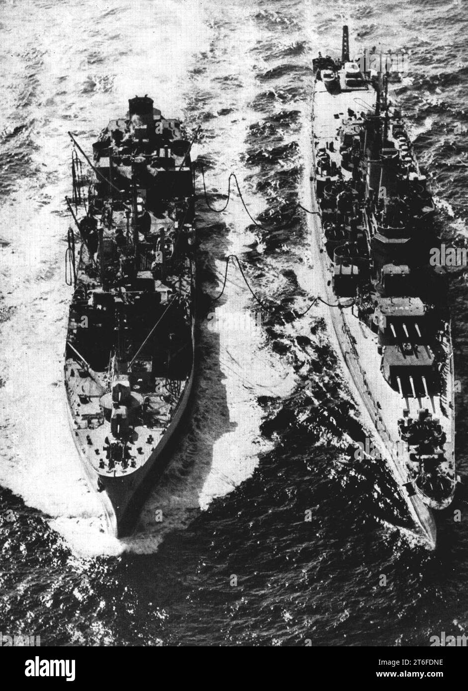 USS Salamonie (AO-26) refuels USS Newport News (CA-148) in 1950 Stock ...