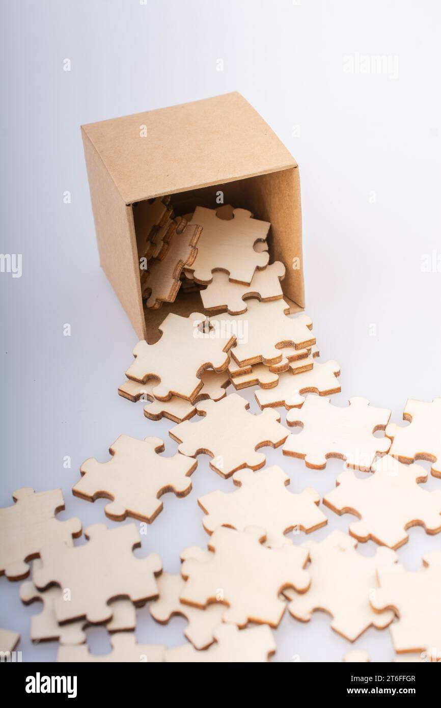 Pieces of jigsaw puzzle coming out of box as business solution concept ...
