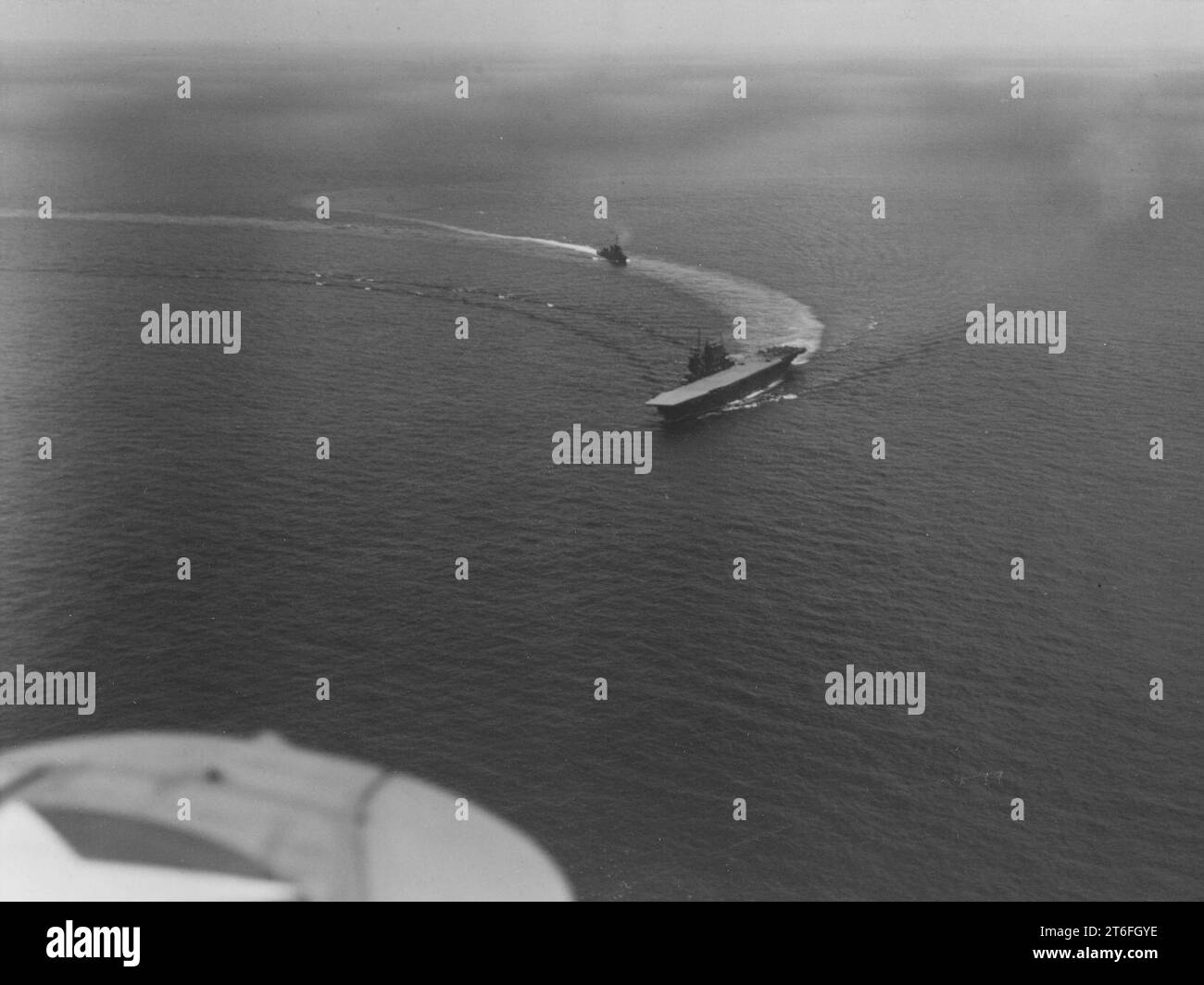 USS Saratoga (CV-3) at sea with a destroyer following in her wake c1942 ...
