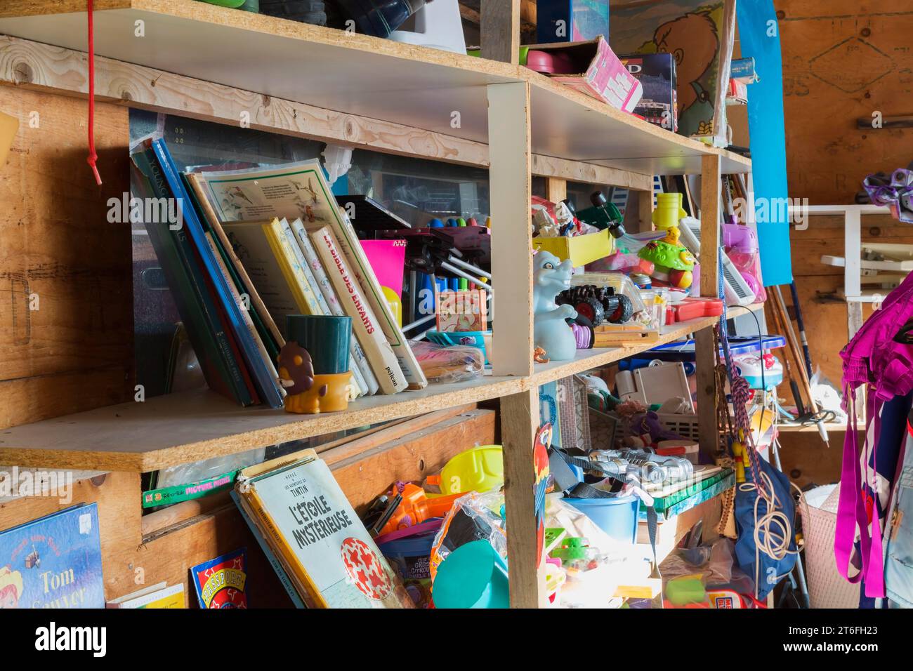 Assorted children's books and toys for sale inside second hand goods ...