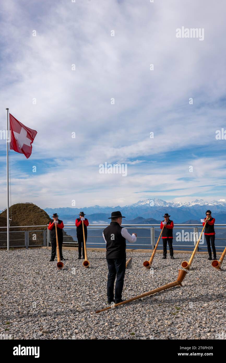 Group of Musicians Playing on Horns of the Alps with Mountainscape and ...