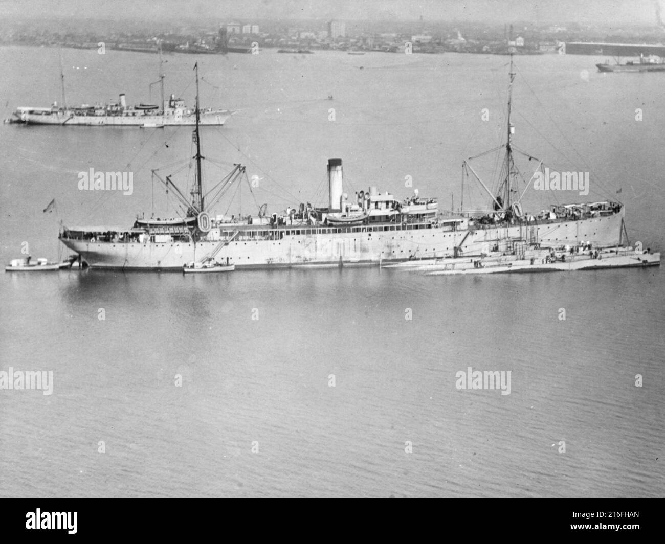 USS Savannah (AS-8) with three S-class submarines alongside, in ...