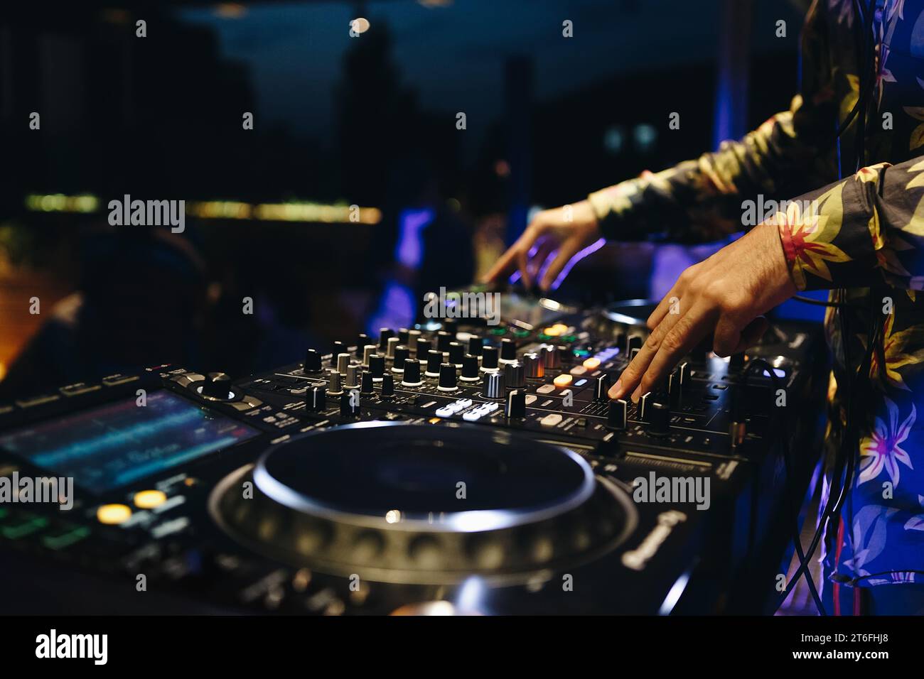 Club DJ playing techno music on a party. Professional disc jockey ...