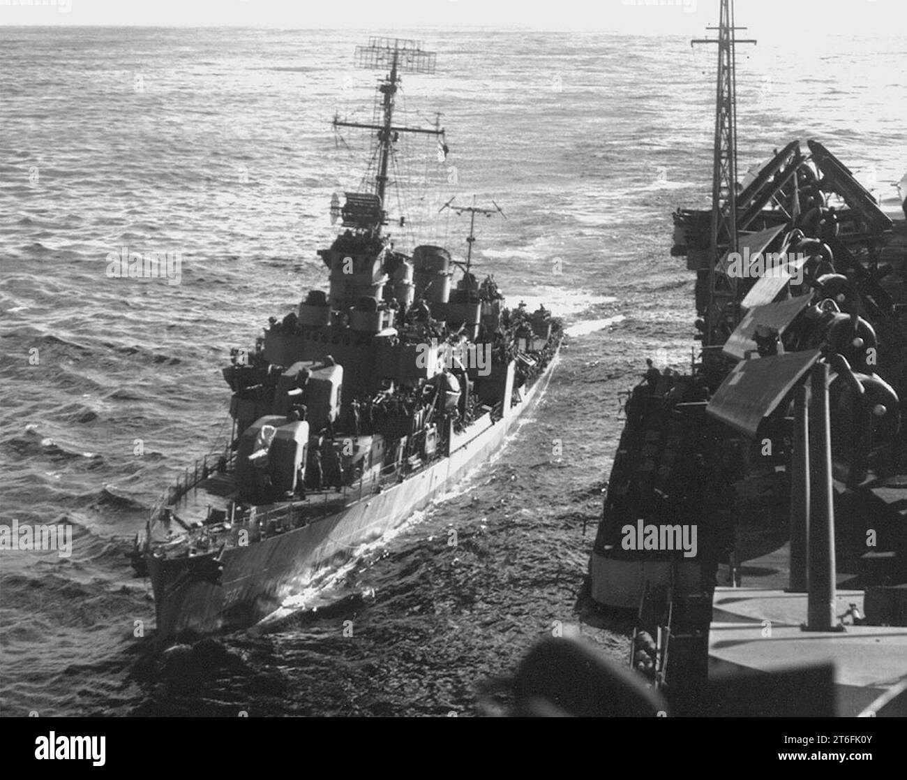 USS Sigsbee (DD-502) alongside of USS Hornet (CV-12), in mid-February ...