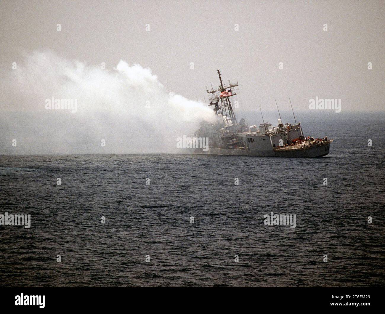 USS Stark (FFG-31) listing after missile hit in the Persian Gulf on 18 ...