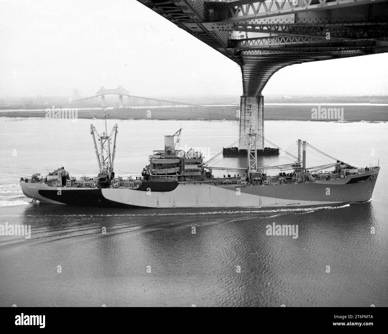 USS Stokes (AKA-68) passing under the Cooper River Bridge at Charleston ...