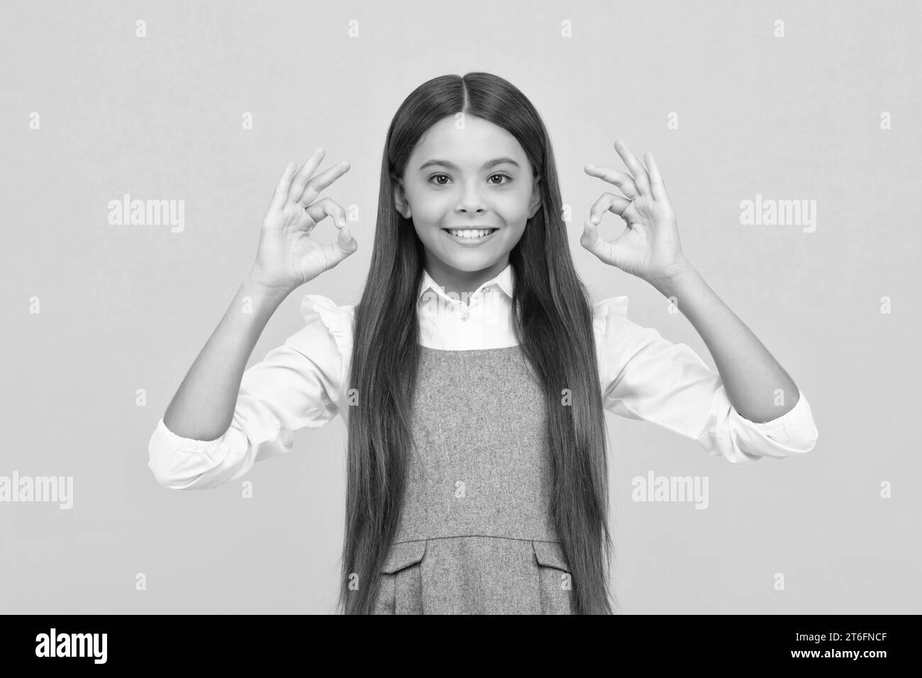 Cute teenager child girl making Ok gesture on yellow background. Happy ...