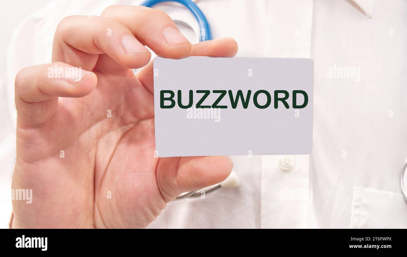 Buzzword word on the card in a man's hand on the background of a white ...