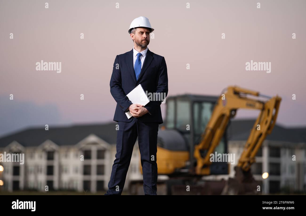 Civil engineer worker at a construction site. Engineer man in front of ...