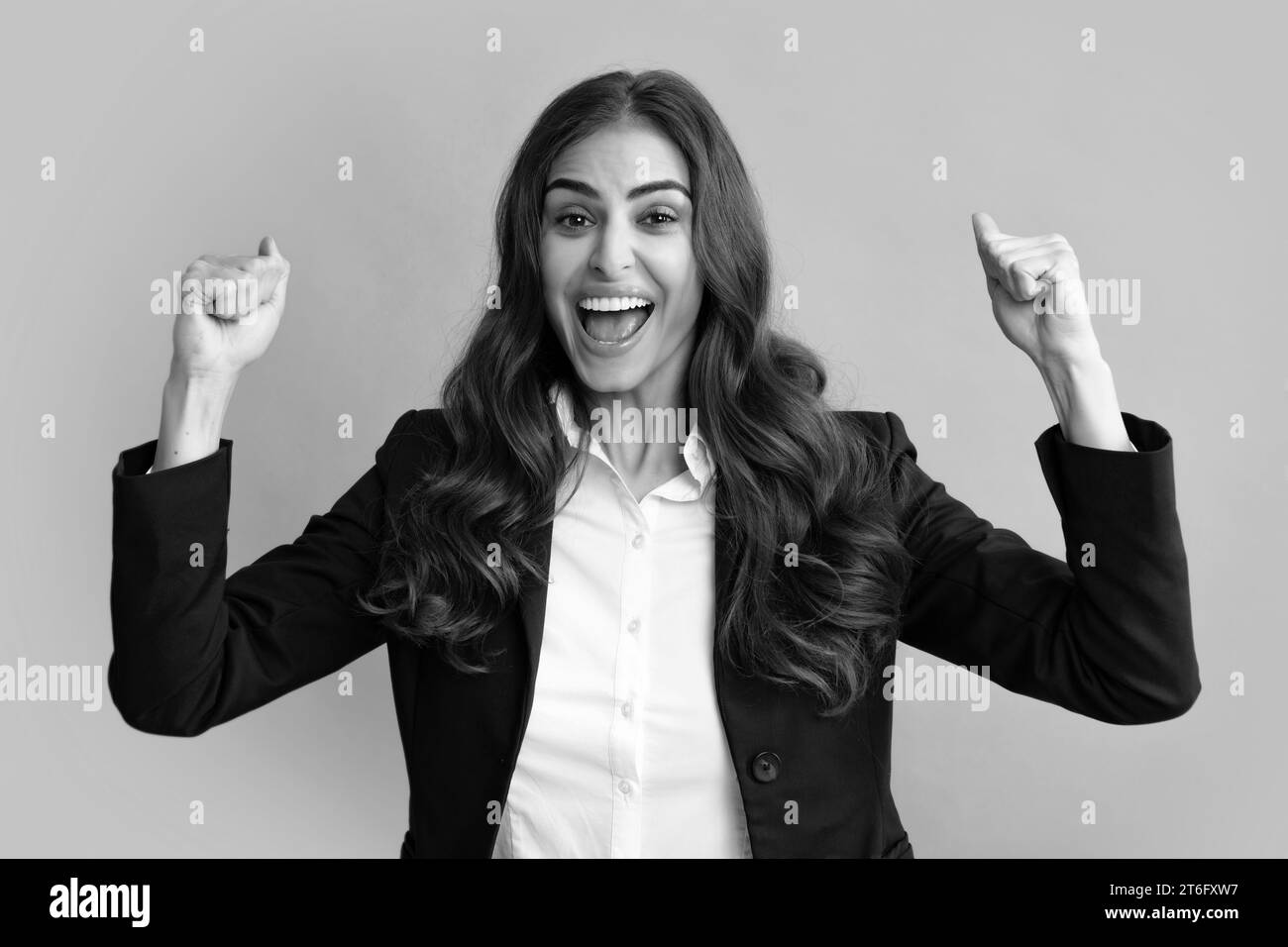 Cheerful beautiful young woman showing winner gesture. Girl celebrating ...