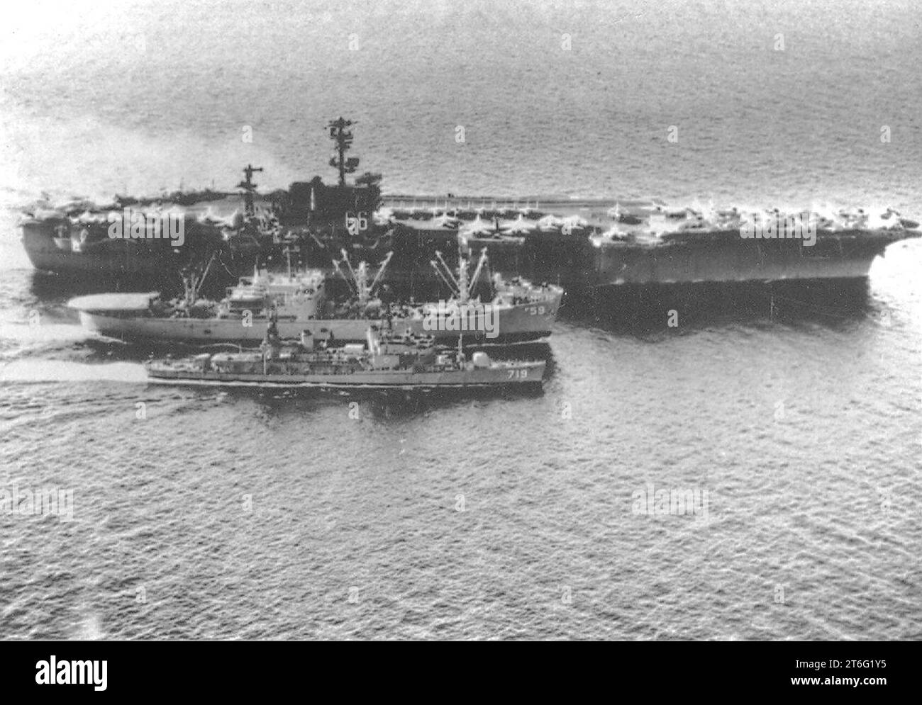 USS Vega (AF-59) replenishing USS America (CVA-66) and USS Epperson (DD ...