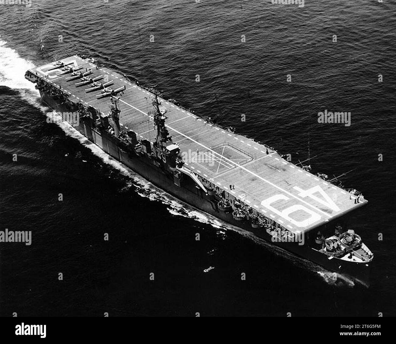 USS Wright (CVL-49) underway at sea with trainig aircraft Stock Photo ...