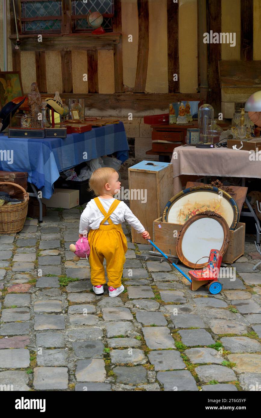 Child with an old fashioned wooden toy at a Flea Market, Brocante ...