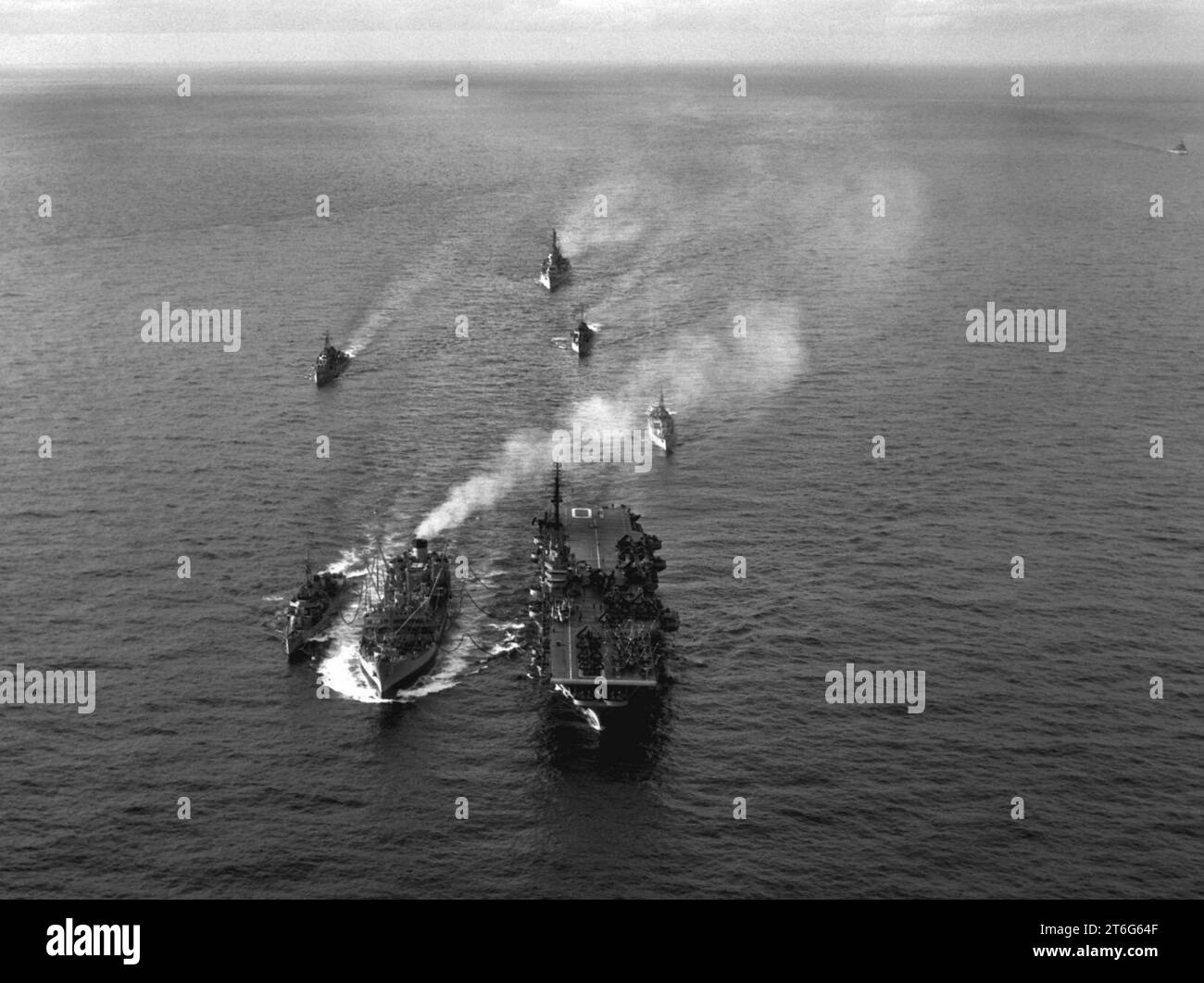 USS Yorktown (CVA-10) and a destroyer being refueled, circa in 1953 ...