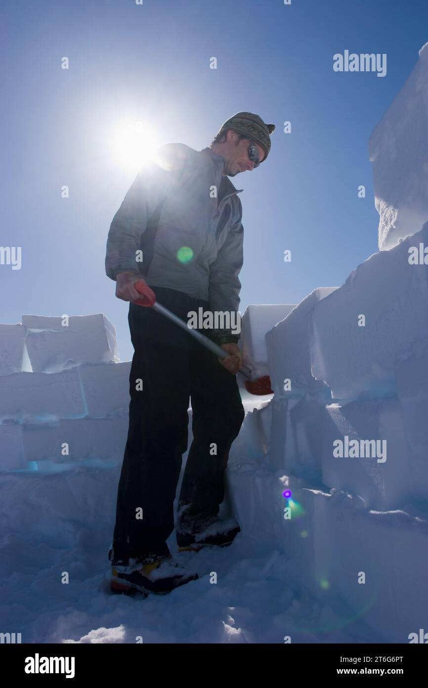 Glacial geology PhD student builds a wall of snow blocks around his ...