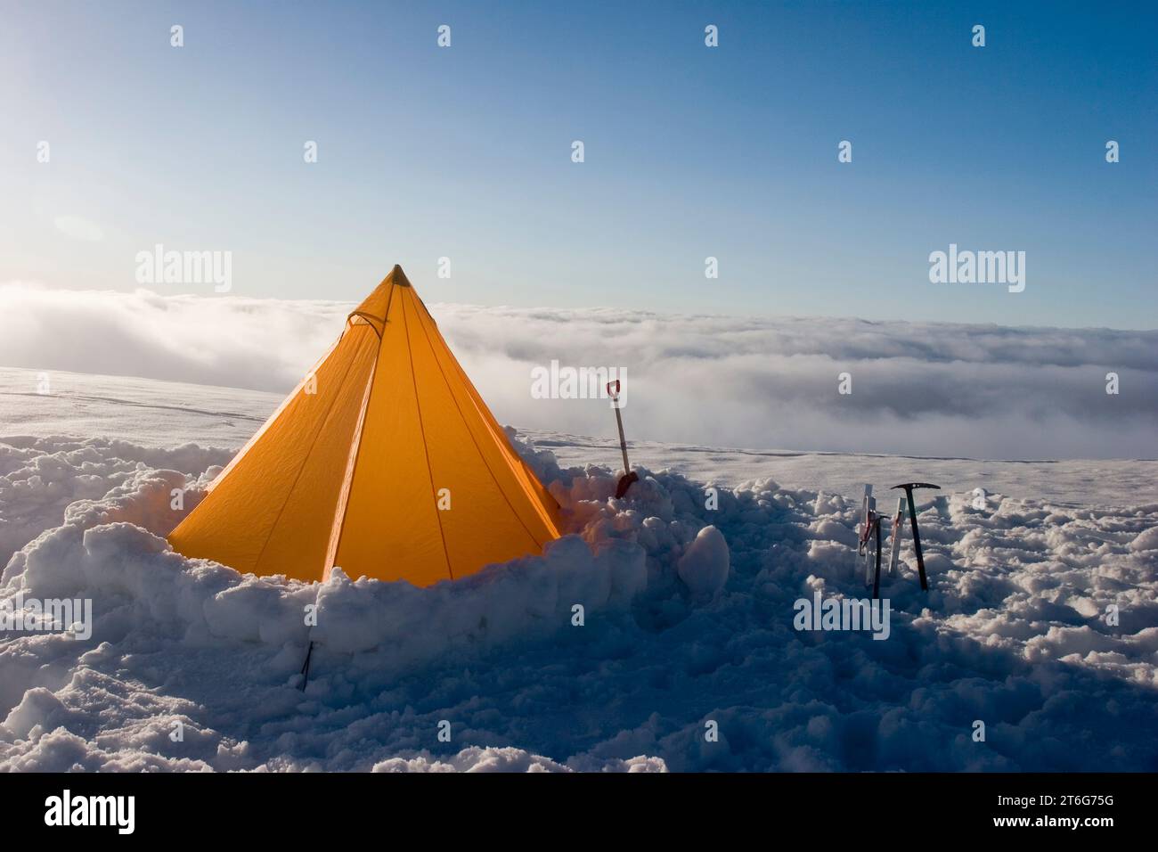 A yellow pyramid tent in the snow, Mt Baker, Washington State Stock ...