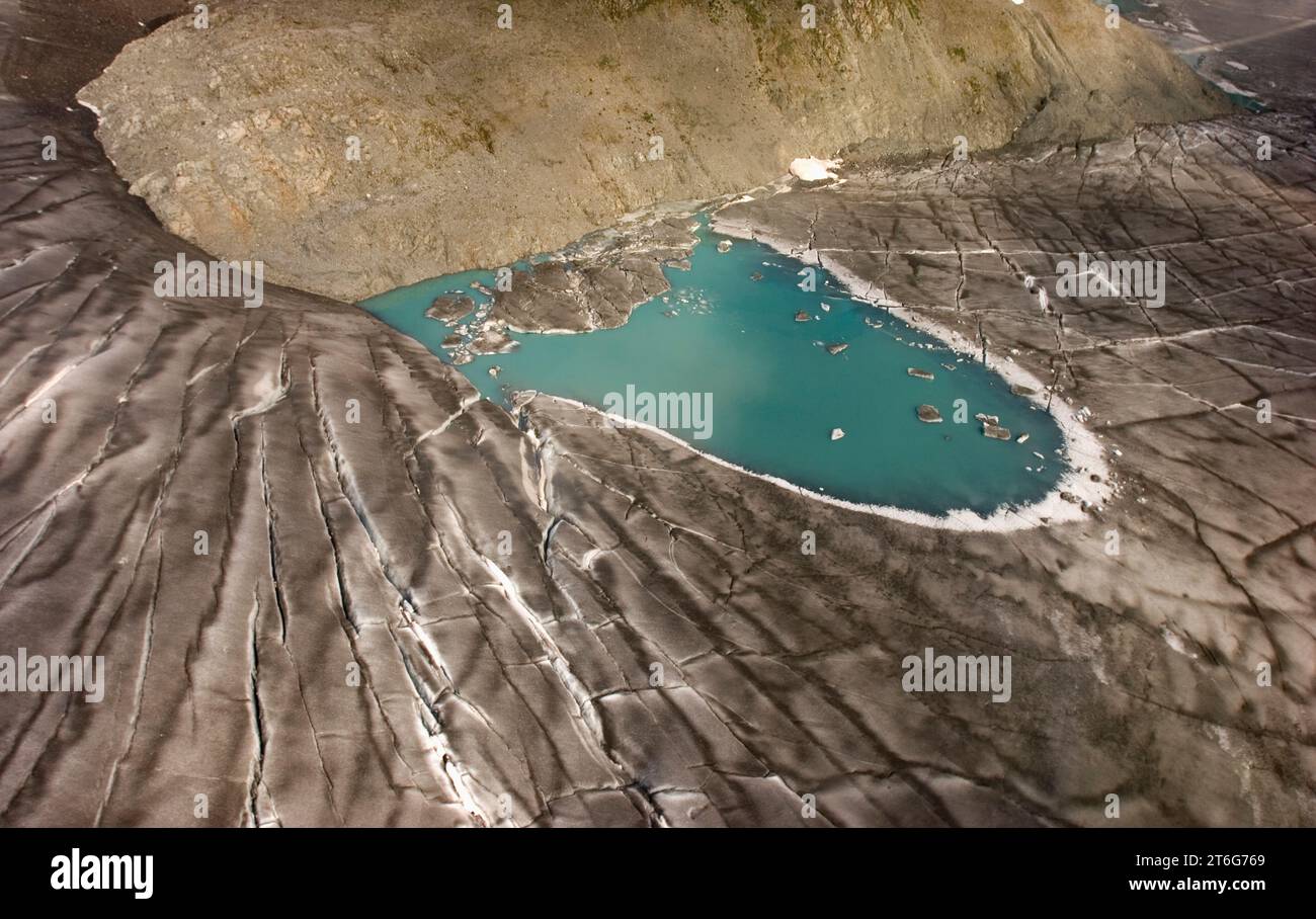 A turquoise supraglacial meltwater pond on top of the Brady Glacier ...