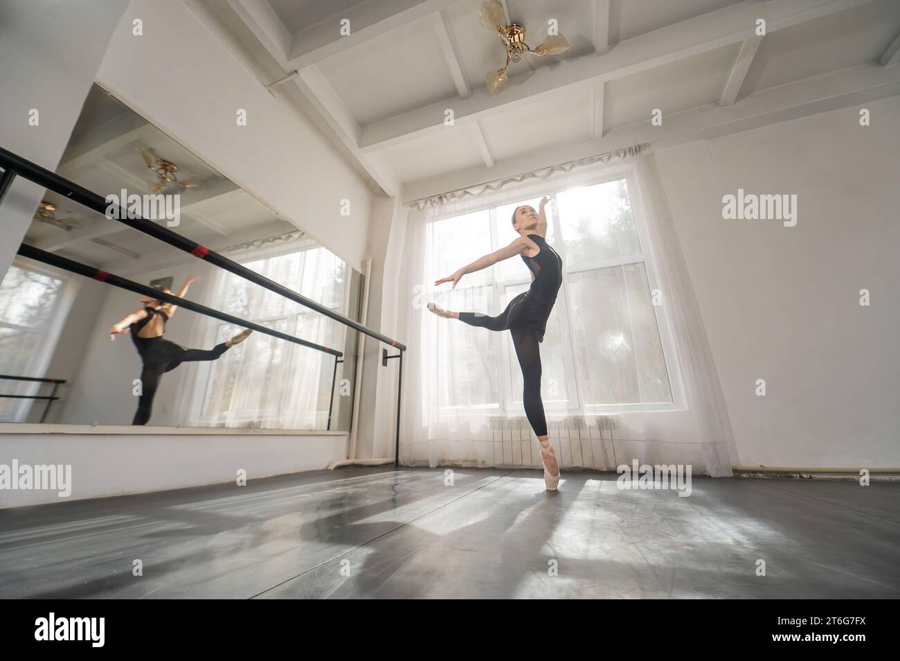 A beautiful Asian woman is dancing at the barre. Ballet dancer Stock ...