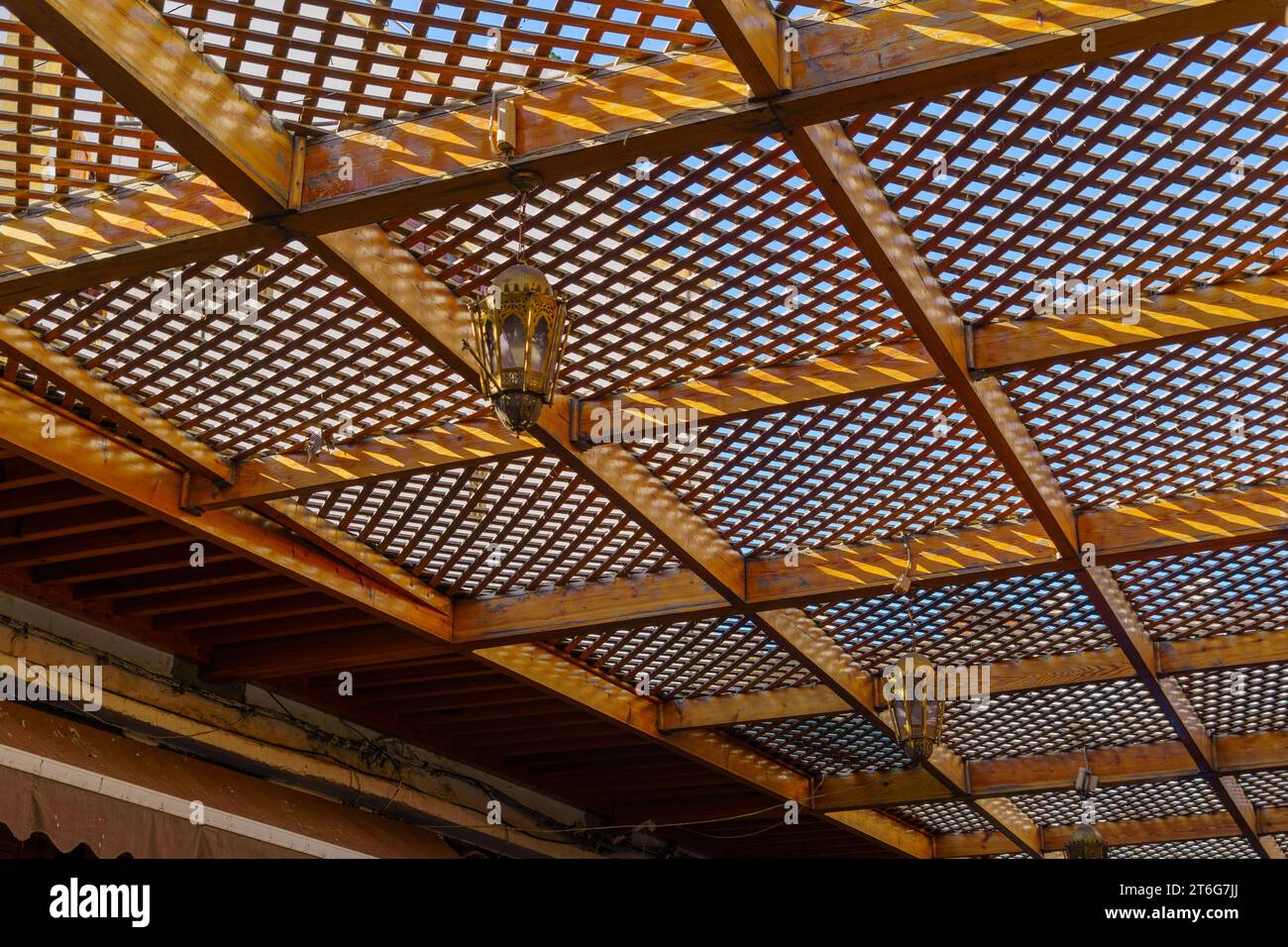 View of a typical wooden grid pattern sunshade in the alleys of the Old ...