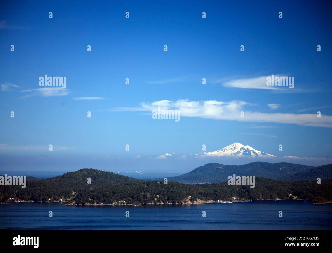 Mount Baker volcano rising up over the waters of the Strait of Georgia ...