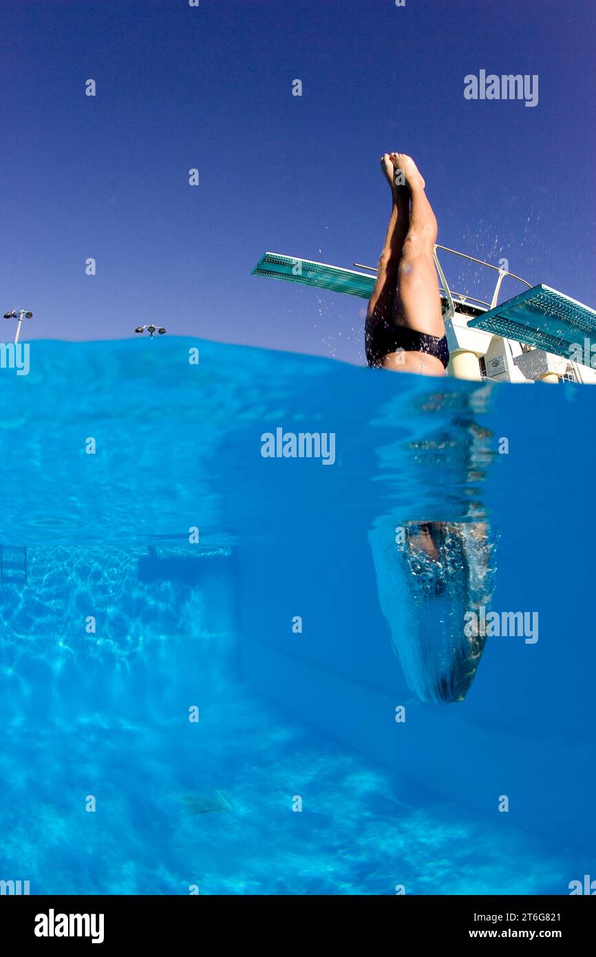 Diver jumping from springboard and entering water, Key Largo, Florida ...