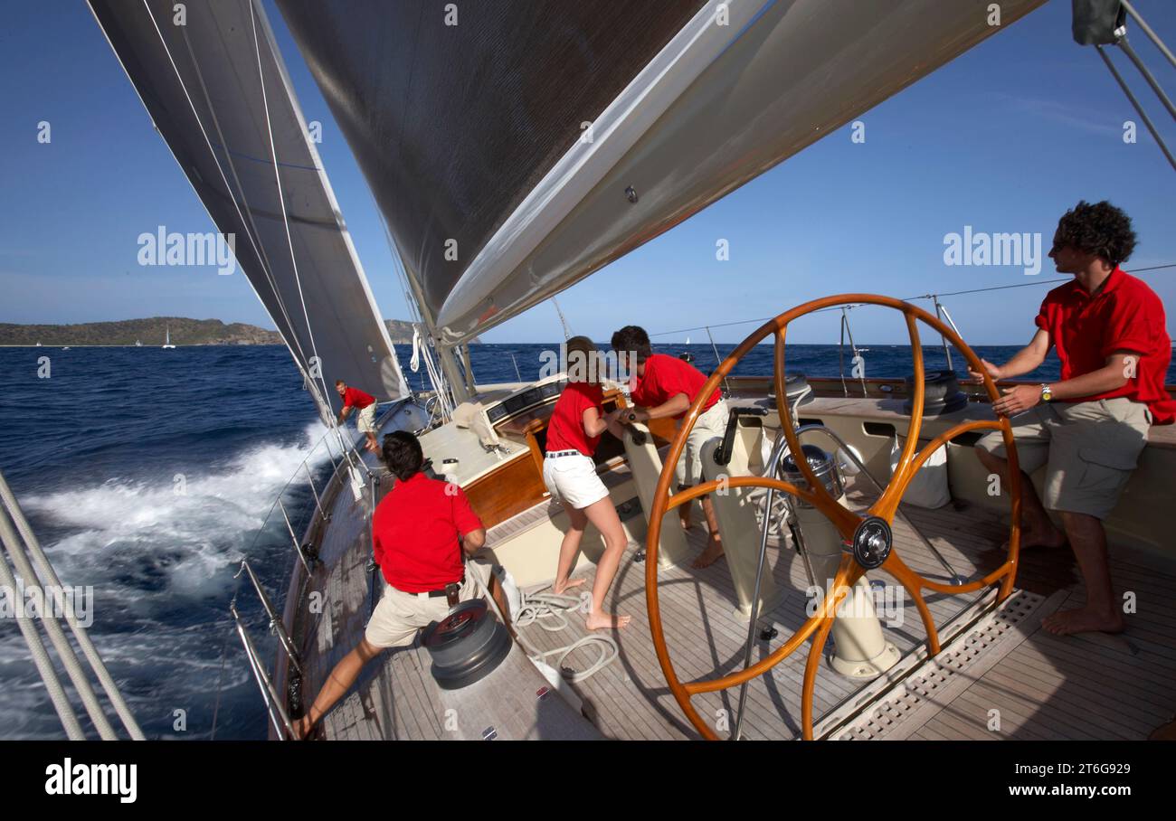 Sailors working together onboard a racing sloop Stock Photo - Alamy
