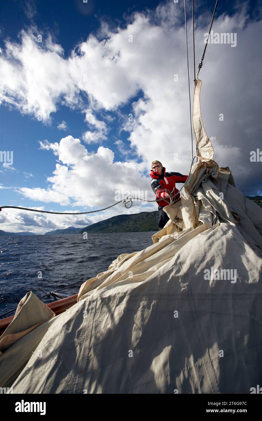 Crew on the bow of a yacht sailing in Scotland Stock Photo - Alamy