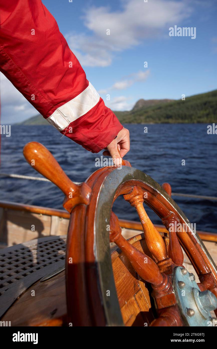 Steady hand at the helm of a yacht while sailing through Caledonian ...