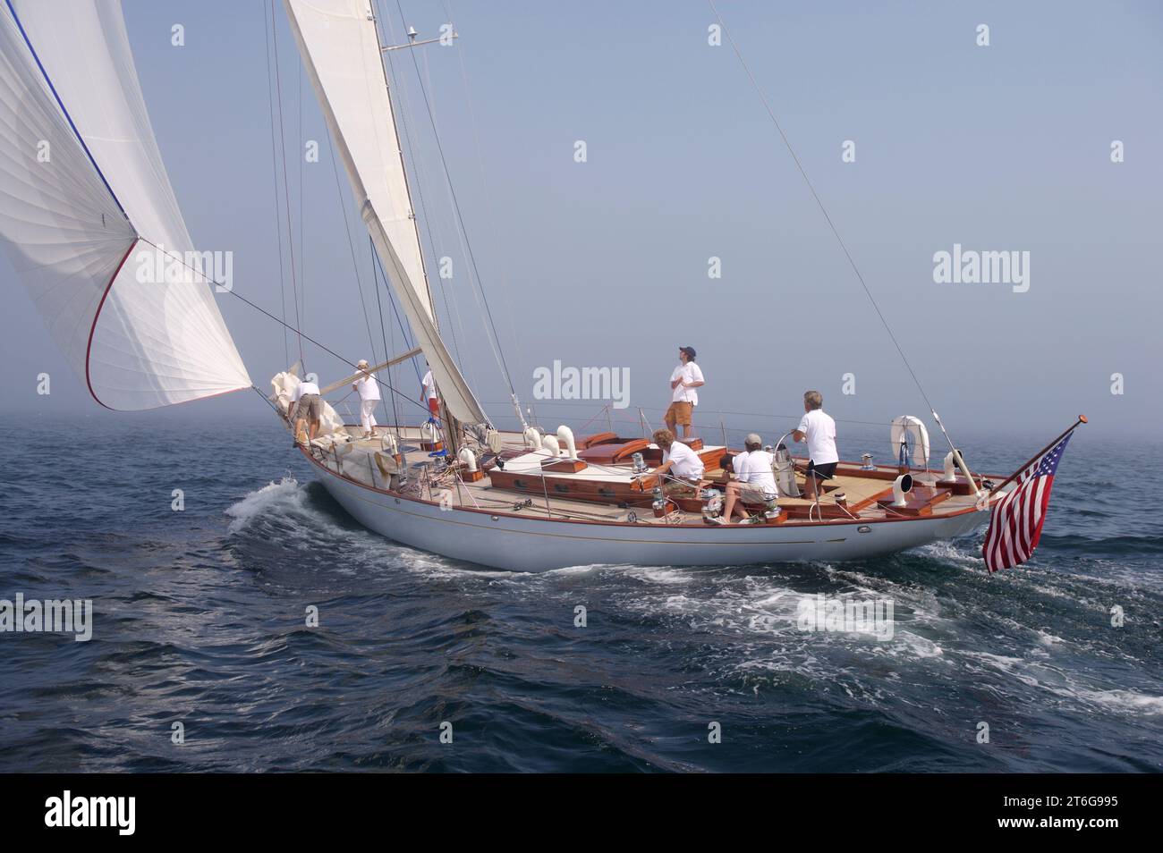 The crew of a classic wooden sailboat races off the coast of Maine ...