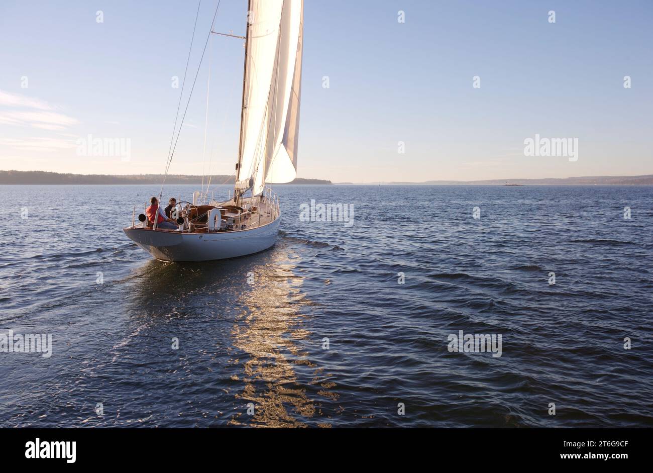 The crew of a sailing yacht takes her out for a sunset cruise off the ...
