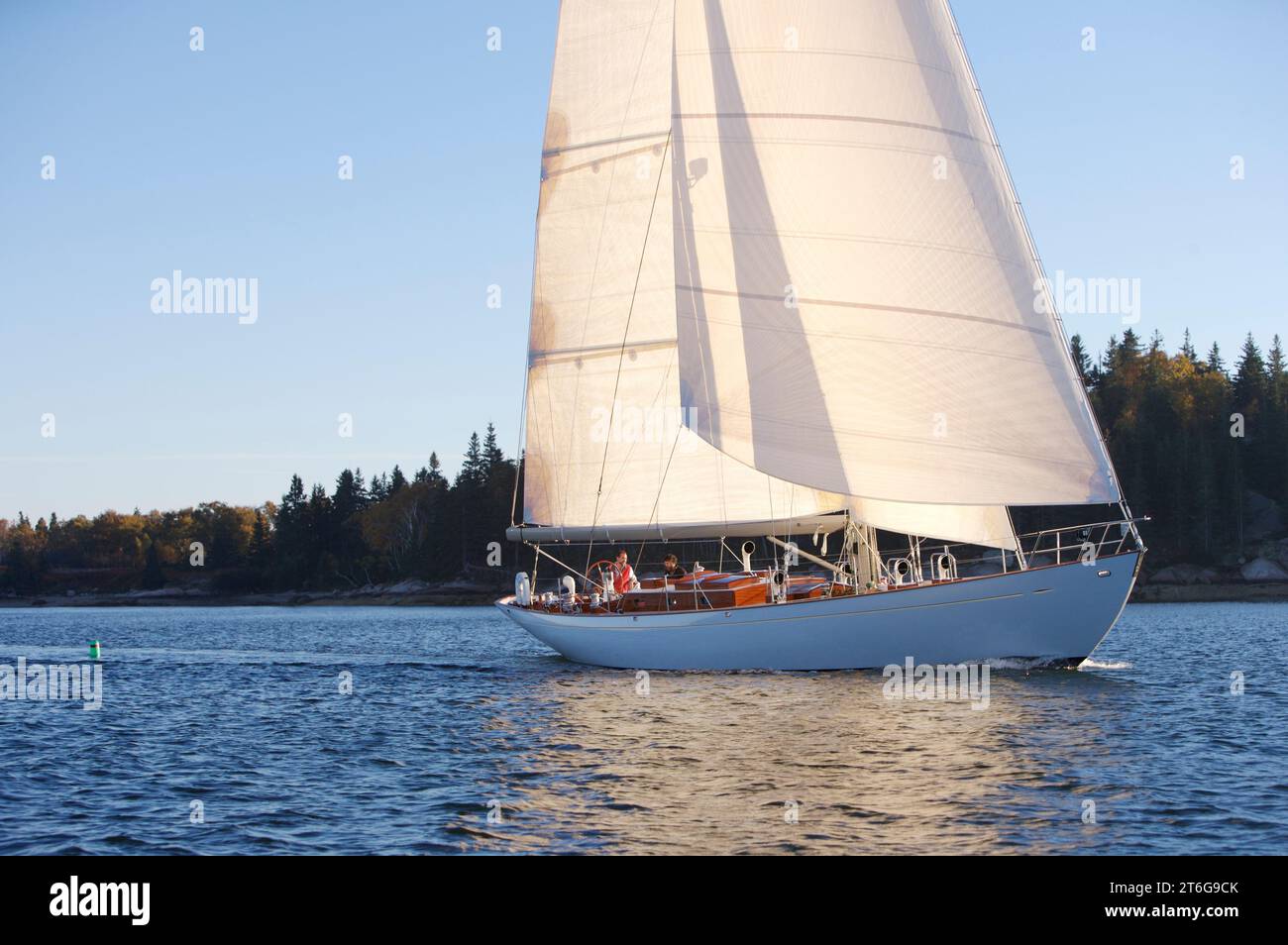 The crew of a sailing yacht takes her out for a sunset cruise off the ...