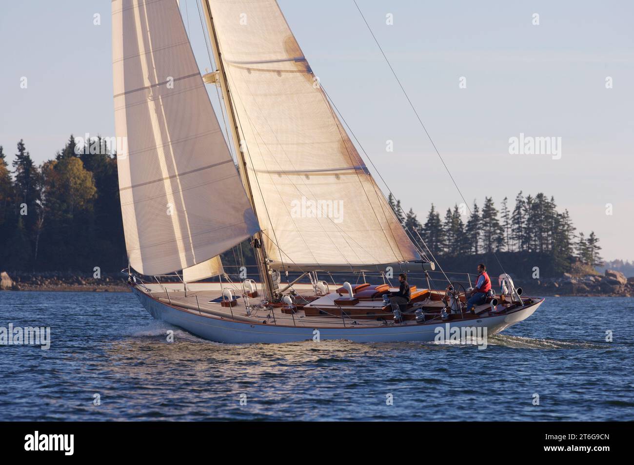 The crew of a sailing yacht takes her out for a sunset cruise off the ...