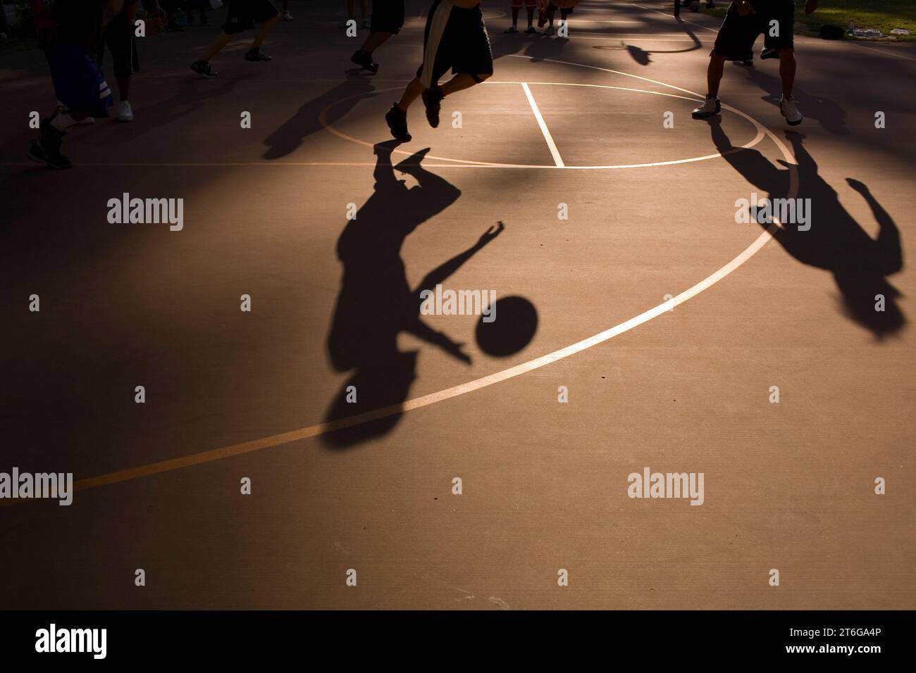 Shadows of basketball players in the evening Stock Photo - Alamy