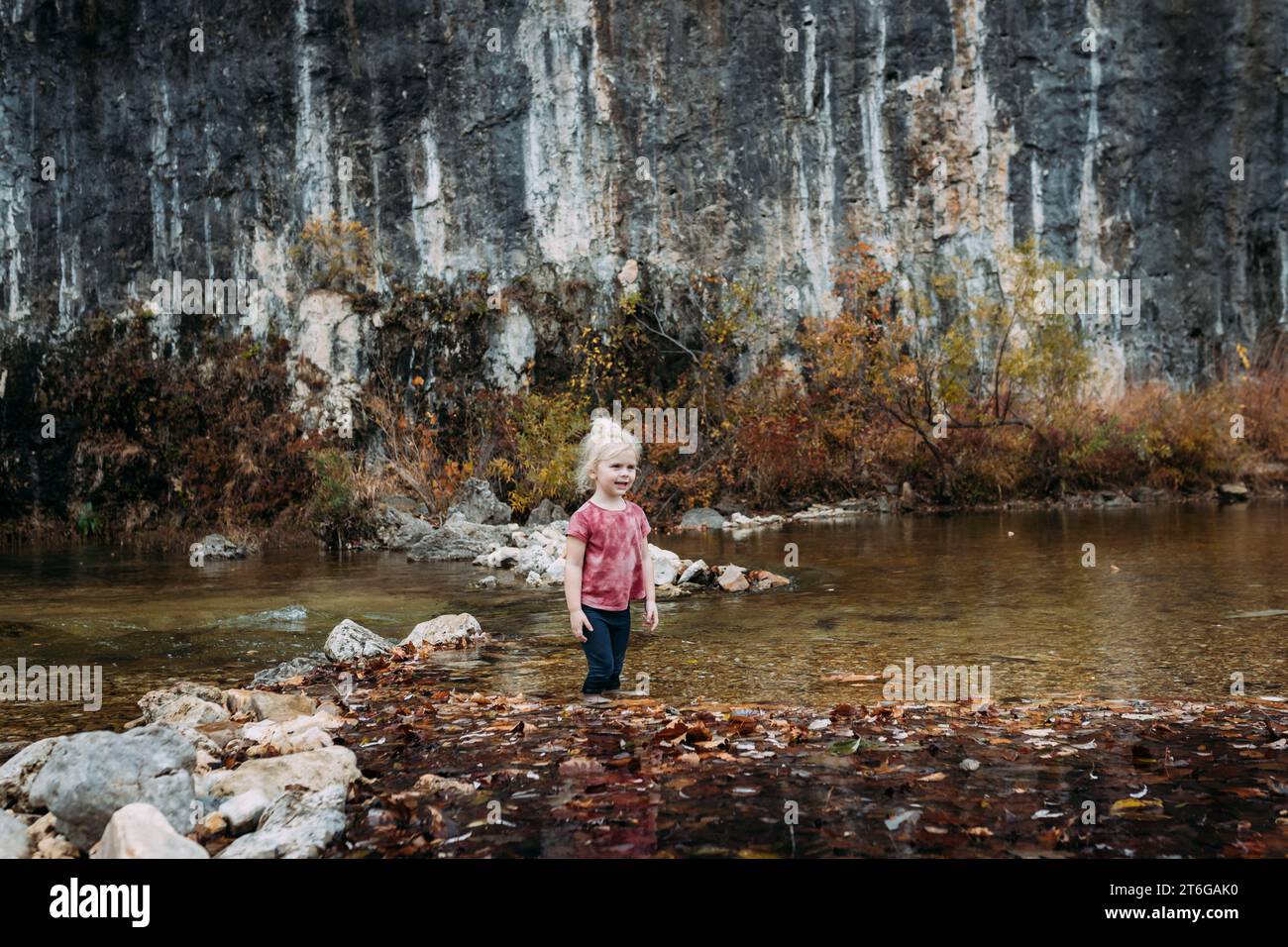 Young child wading in river during autumn day Stock Photo - Alamy
