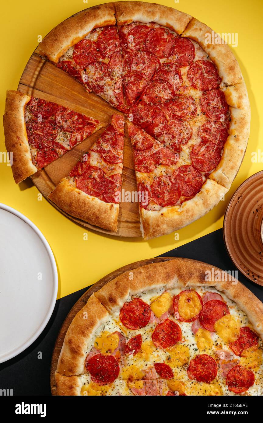 traditional Italian pizza with salami and vegetables on a black Stock ...