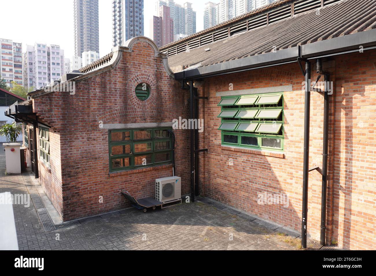 Brick building & gasometer, gas holder Stock Photo - Alamy