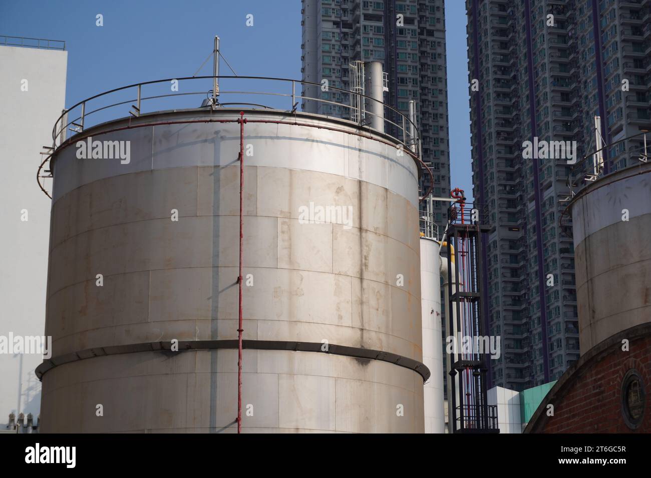 Brick building & gasometer, gas holder Stock Photo - Alamy
