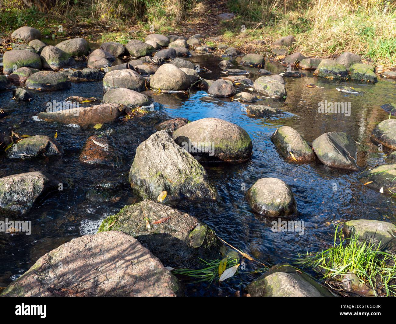 Water flows among the stones. Flow of water and stones. Stones in ...