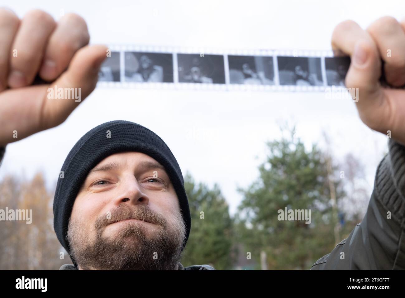 Man looks with interest at a vintage photographic film. Concept of ...