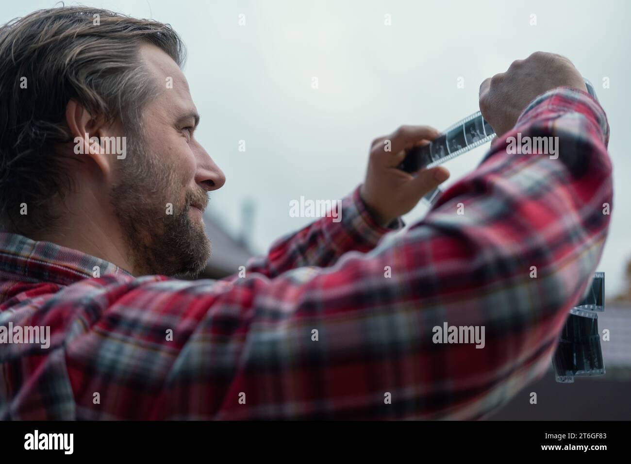 Man looks with interest at a vintage photographic film. Concept of ...
