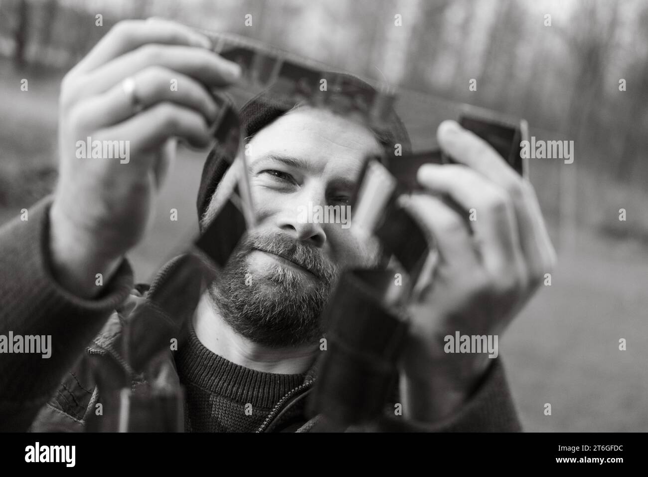 Man looks with interest at a vintage photographic film. Concept of ...