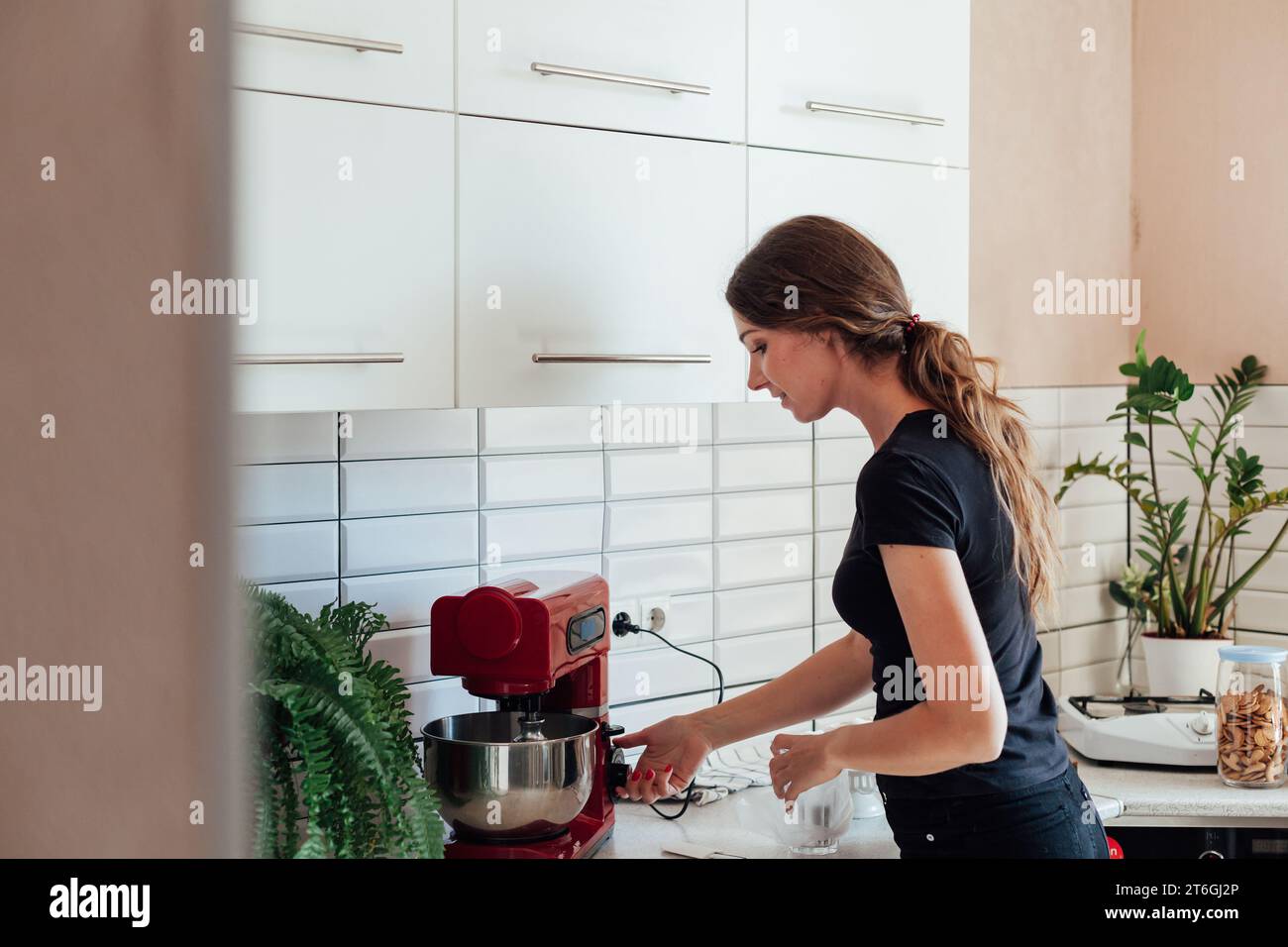 Female housewife cooking food in kitchen Stock Photo - Alamy