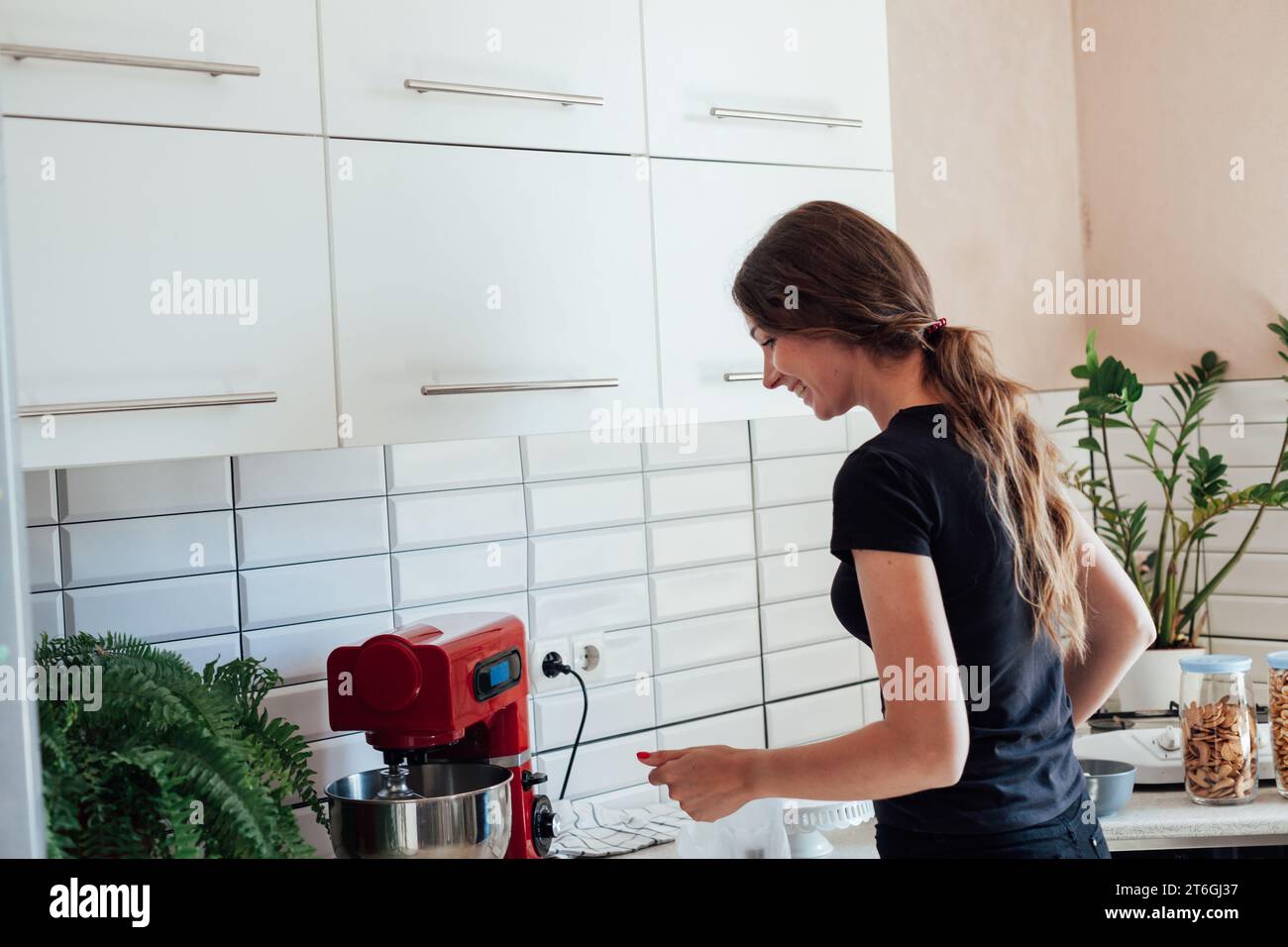 Female housewife cooking food in kitchen Stock Photo - Alamy