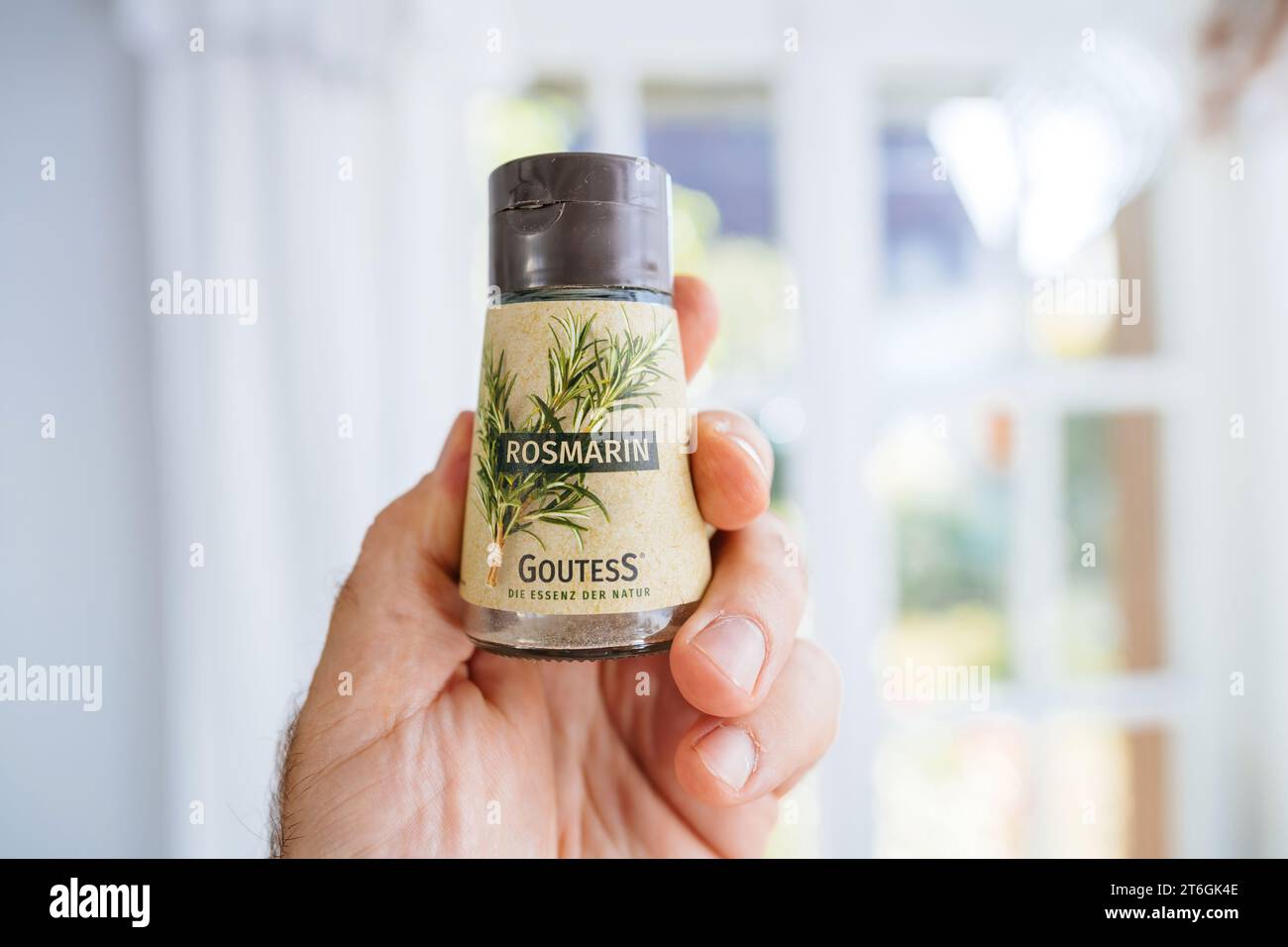 Frankfurt, Germany - Jun 12, 2023: Close-up of a hand holding a bottle ...