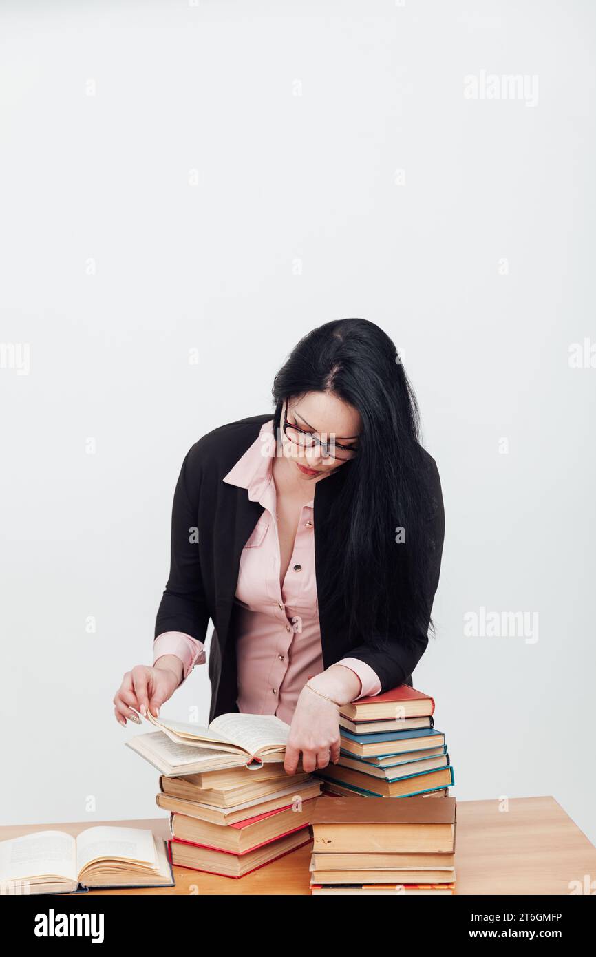 Female school librarian with books for university study Stock Photo - Alamy