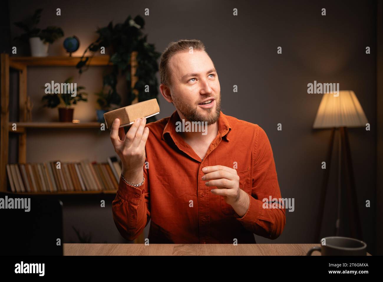 male blogger filming video review of modern gadget at home. Famous ...