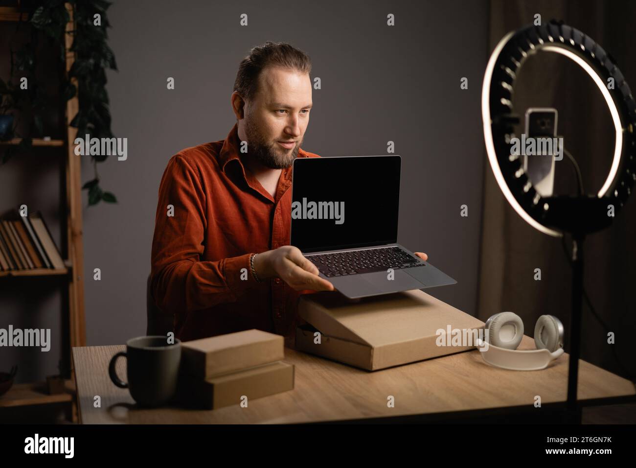 Influencer promoting new model of laptop computer and recommending ...